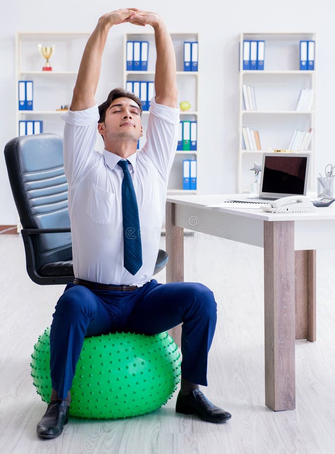 Young Businessman Doing Sports Stretching at Workplace Stock Image ...