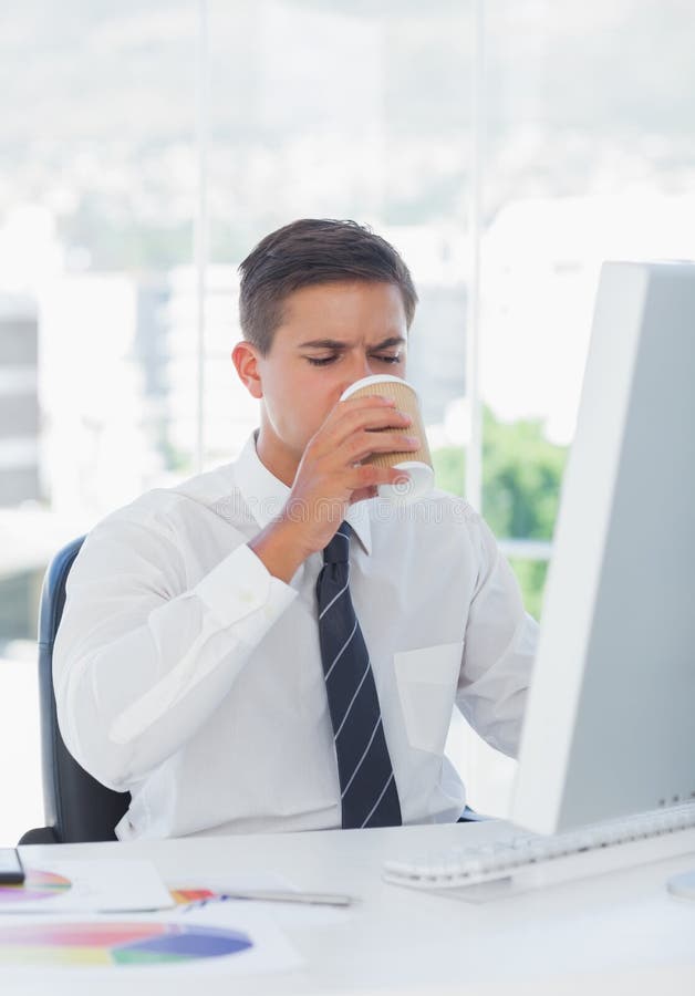 Young Businessman Drinking Coffee at His Desk Stock Image - Image of ...
