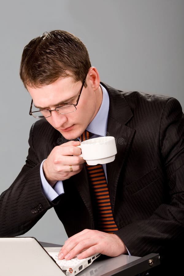 Young Businessman Drinking Coffee at Workplace Stock Photo - Image of ...
