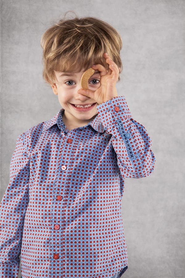 Young Businessman Eating a Cake during Break, Looks through the Stock ...