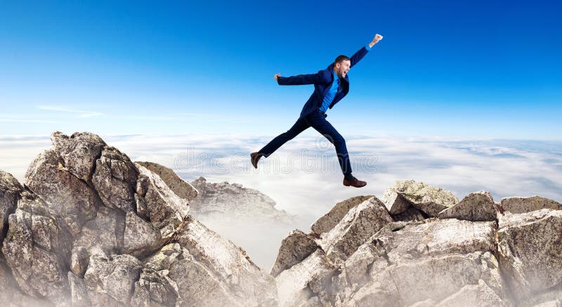 Young Businessman Flying through the Gap among Mountains. Stock Photo ...