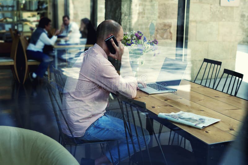 Young Businessman Having Lunch in a Restaurant and Talking on the Phone ...