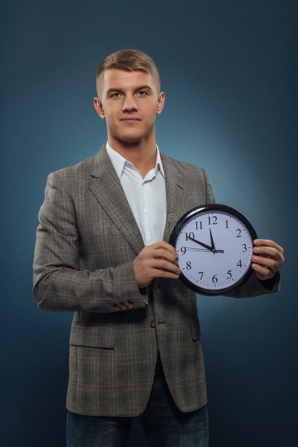 Young Businessman Holding a Clock Stock Image - Image of hour, people ...