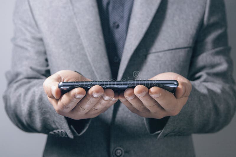 Young Businessman Holding a Phone As a Stand Stock Image - Image of ...