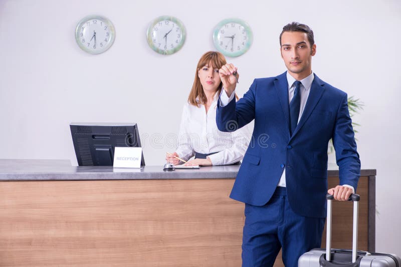 Young Businessman at Hotel Reception Stock Photo - Image of client ...
