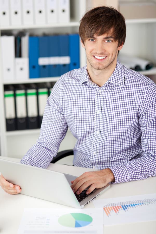 Young Businessman with Laptop in Office Stock Photo - Image of ...