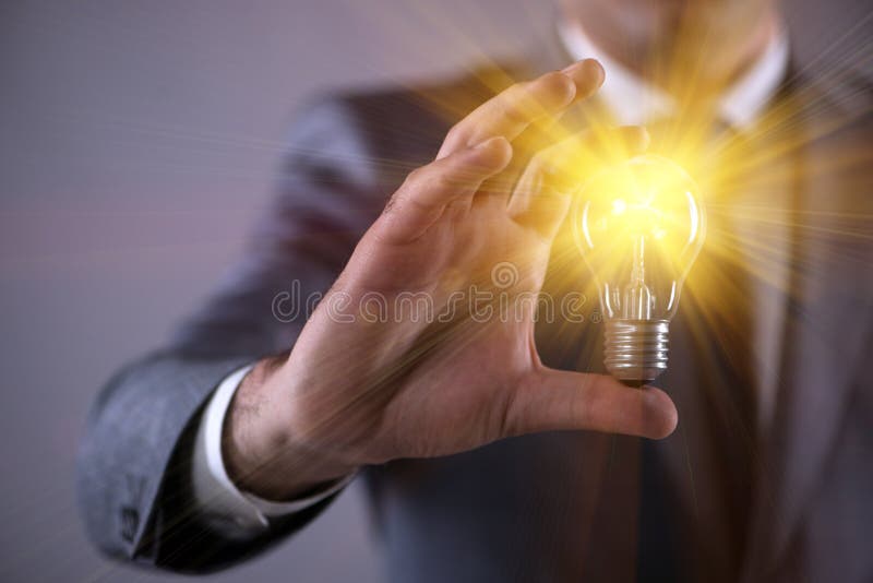 The Young Businessman with Light Bulb in Idea Concept Stock Photo ...