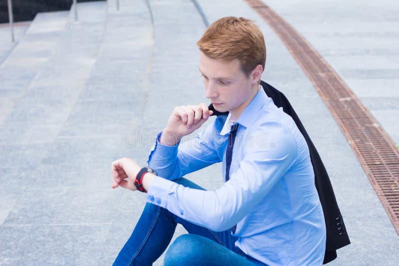 Young Businessman Looking at the Clock and Waiting for the Client Stock ...