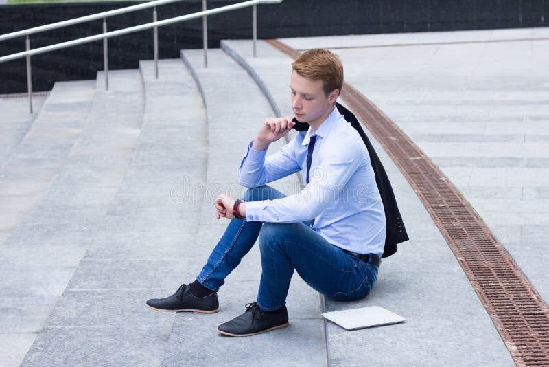 Young Businessman Looking at the Clock and Waiting for the Client Stock ...