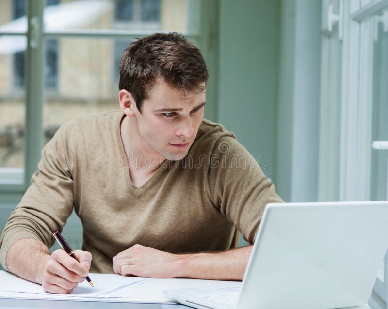 Man Writing at Desk in Busy Creative Office Stock Photo - Image of ...