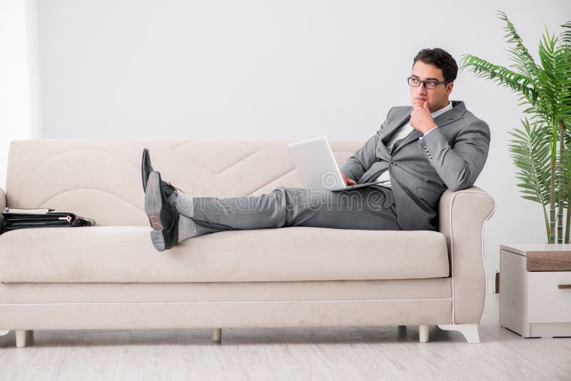 The Young Businessman Lying on the Sofa Stock Image - Image of monitor ...