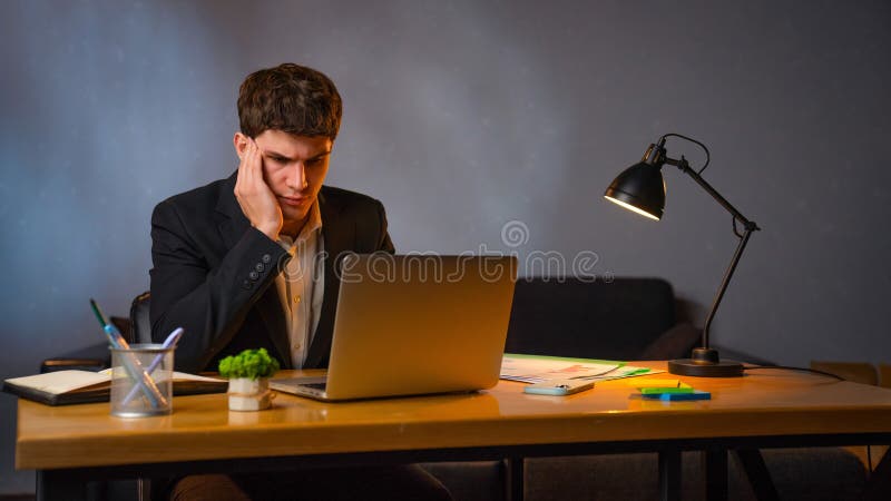 Young Businessman in the Office Working Late at Evening, Man Sitting at ...