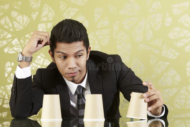 Young Businessman Playing the Shell Game. Conceptual Image Stock Image ...