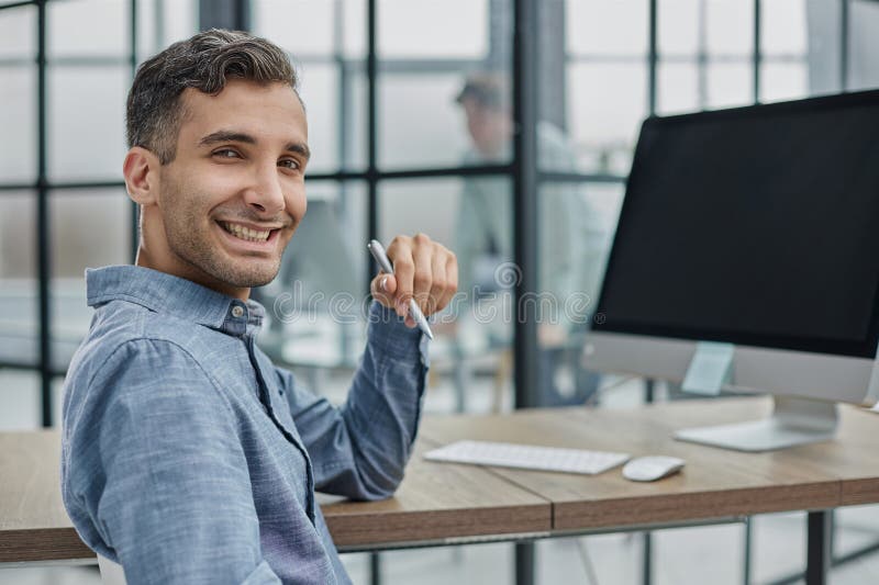 Young Businessman Posing at the Camera in a Modern Office. Stock Image ...