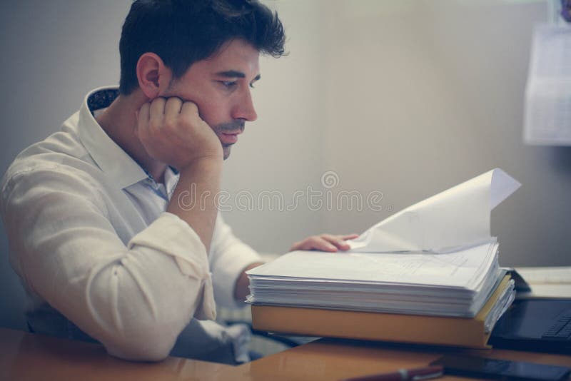 Young Businessman Reading a Contract. Stock Photo - Image of business ...