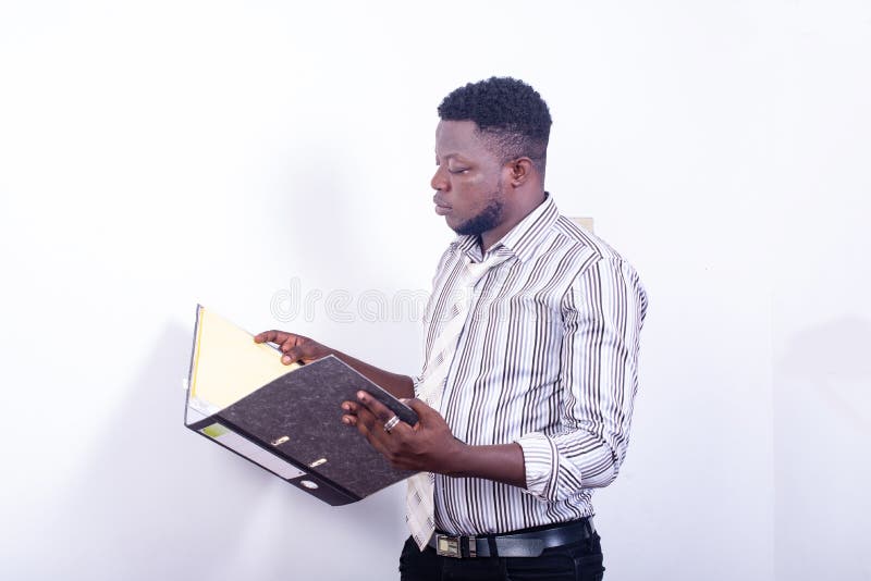 Young Businessman Reading Files in a Filing Cabinet Stock Photo - Image ...