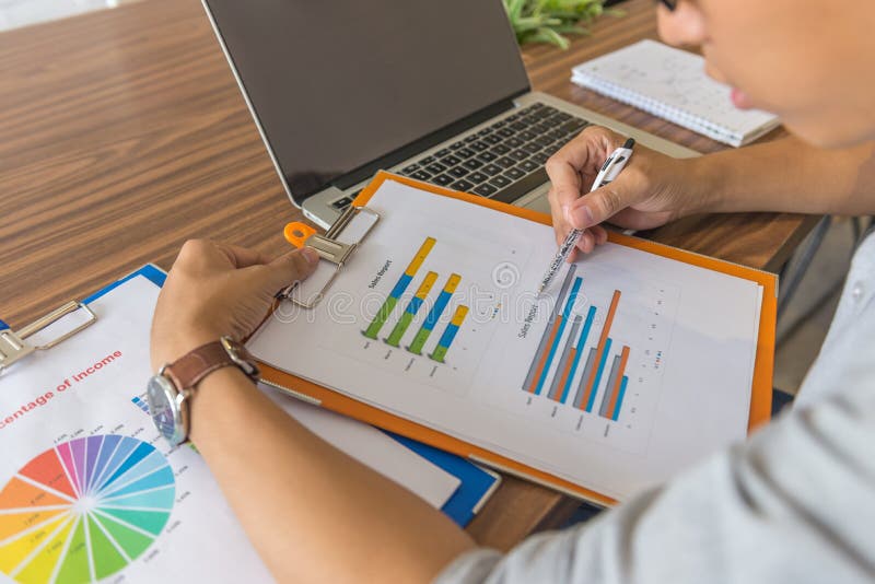 Young Businessman Reading Financial Graph in Document Stock Image ...