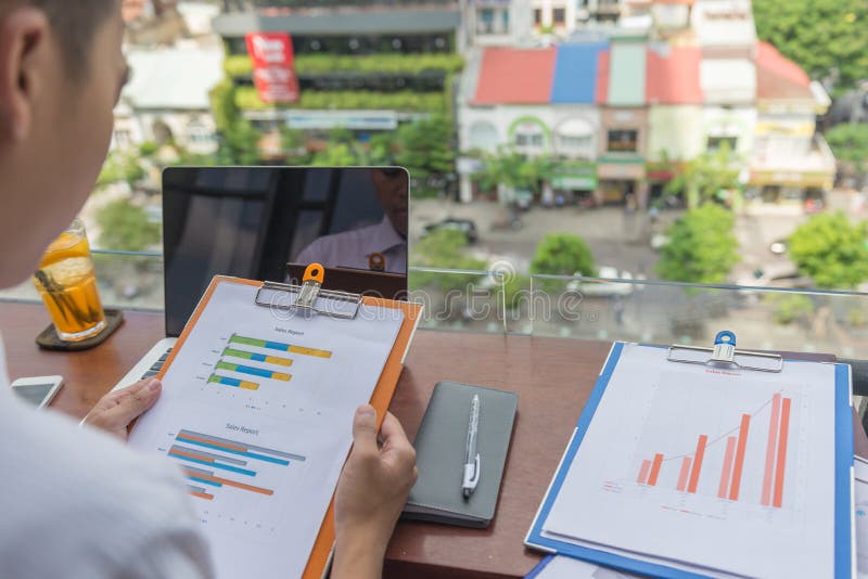 Young Businessman Reading Report Stock Photo - Image of office, busy ...