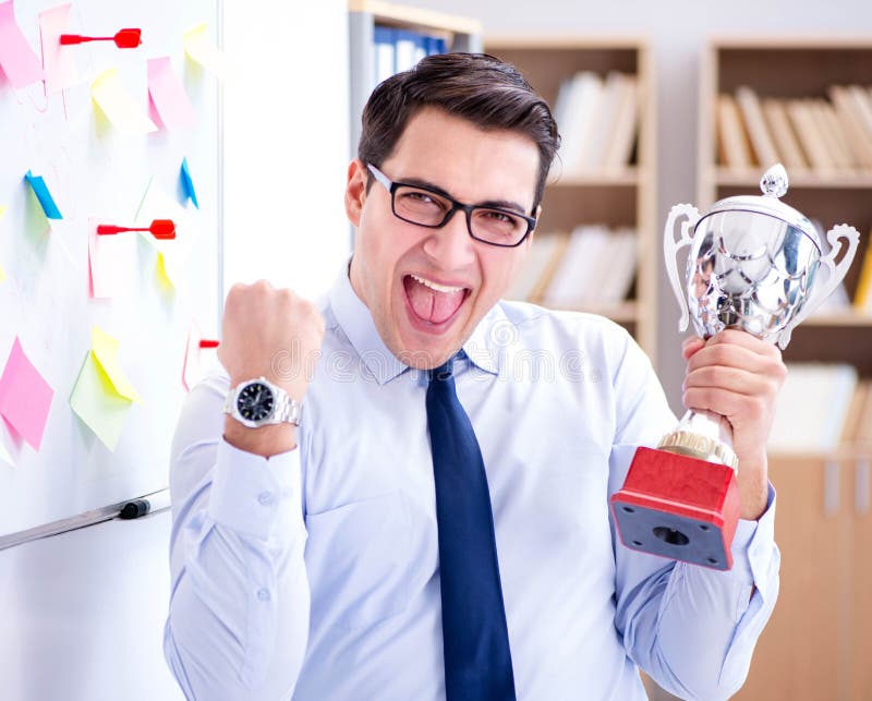 Young Businessman Receiving Prize Cup in Office Stock Image - Image of ...