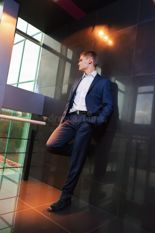 Young Businessman Resting on Wall Stock Image - Image of good, model ...