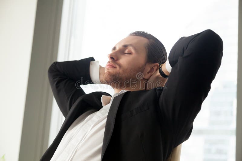 Young Businessman Resting at Work with His Hands Behind Head. Stock ...