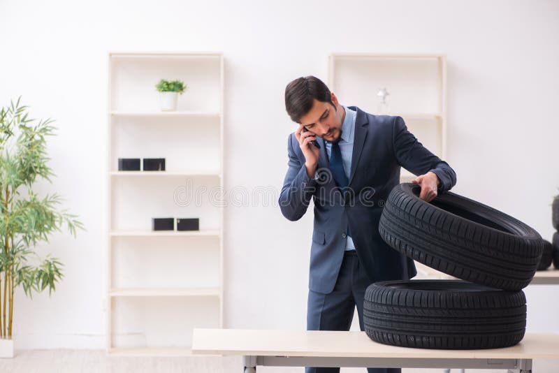 Young Man Selling Tires in the Office Stock Image - Image of client ...