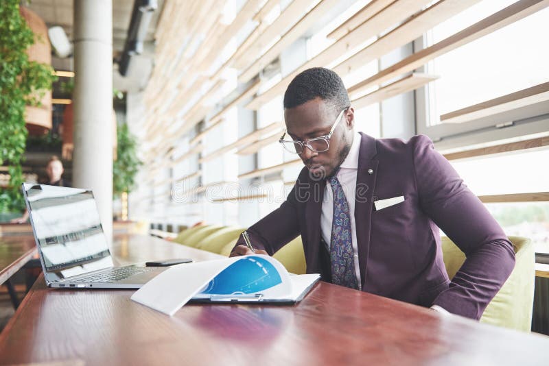 A Young Businessman Signs a Contract in a Conference Room Stock Photo ...