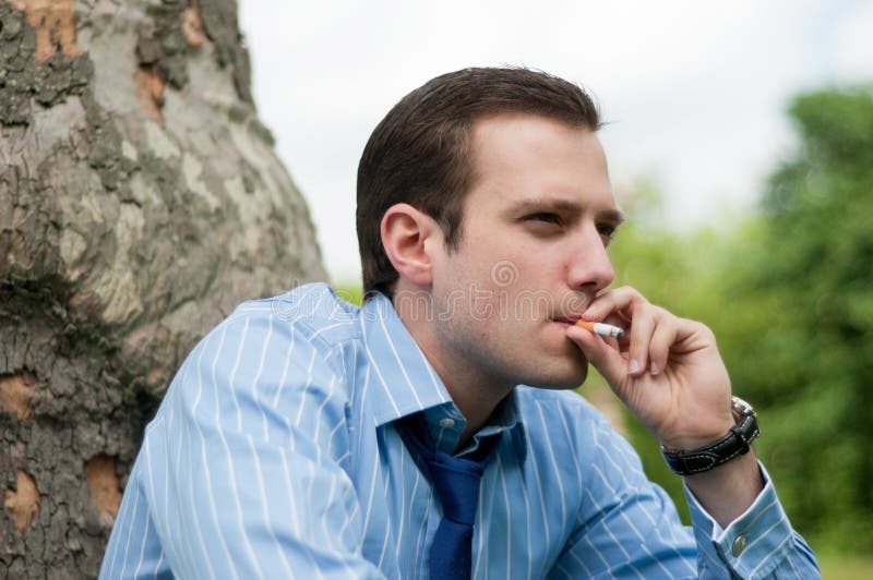 Young Businessman Sitting Against a Tree Stock Image - Image of ...