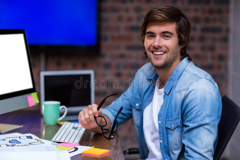 Young Businessman Sitting at Desk Stock Photo - Image of focus ...