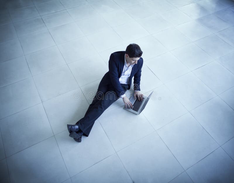 Young Businessman Sitting on the Floor Using His Laptop Stock Image ...