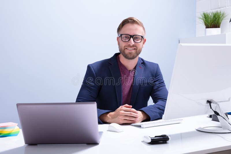 Young Businessman Sitting in Front of Computer Stock Image - Image of ...