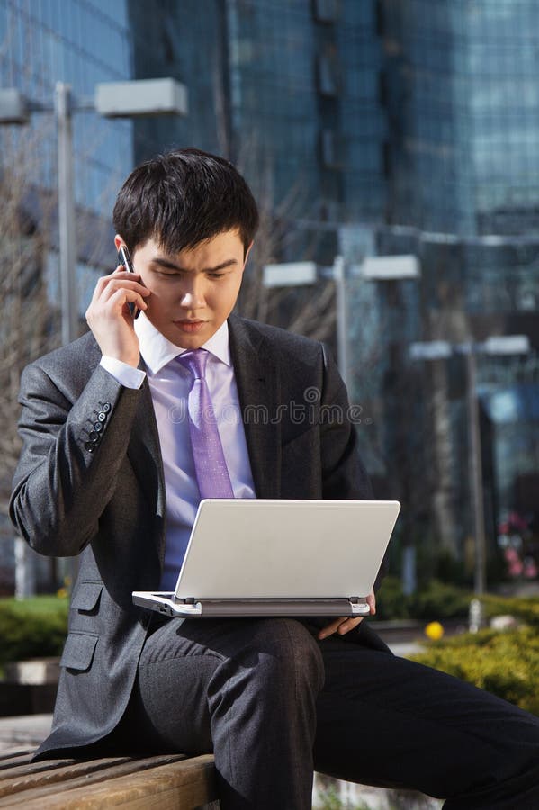 Young Businessman Sitting with Laptop. Stock Photo - Image of outdoor ...