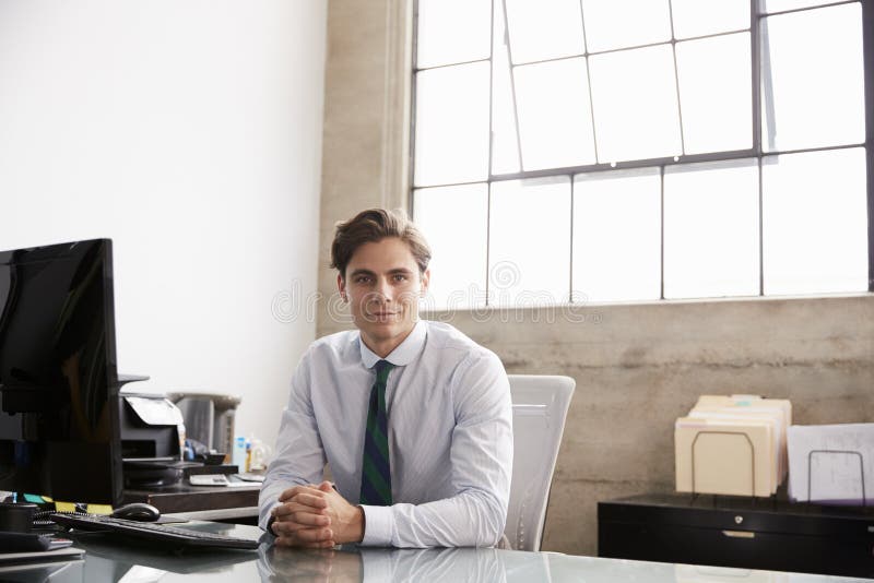 Young Businessman Sitting at Office Desk Smiling To Camera Stock Image ...
