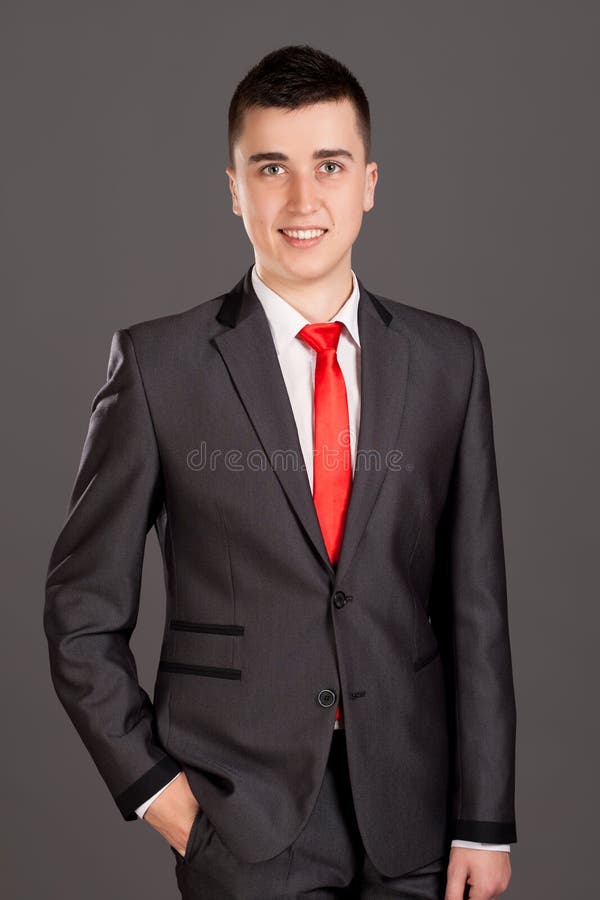 Young Businessman Standing on Grey Background Stock Photo - Image of ... Young Businessman Standing on Grey Background Stock Photo - Image of ...