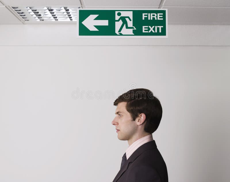 Young Businessman Standing Under Exit Sign Stock Image - Image of pride ...