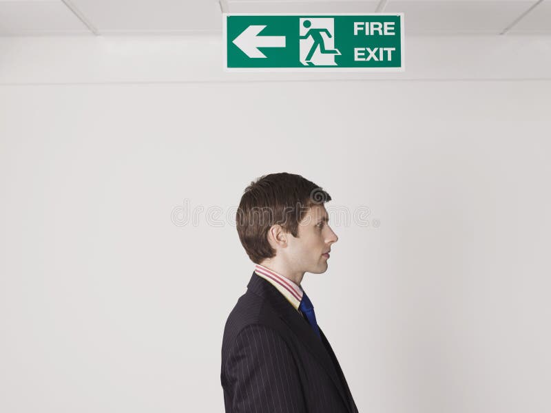 Young Businessman Standing Under Exit Sign Stock Image - Image of pride ...