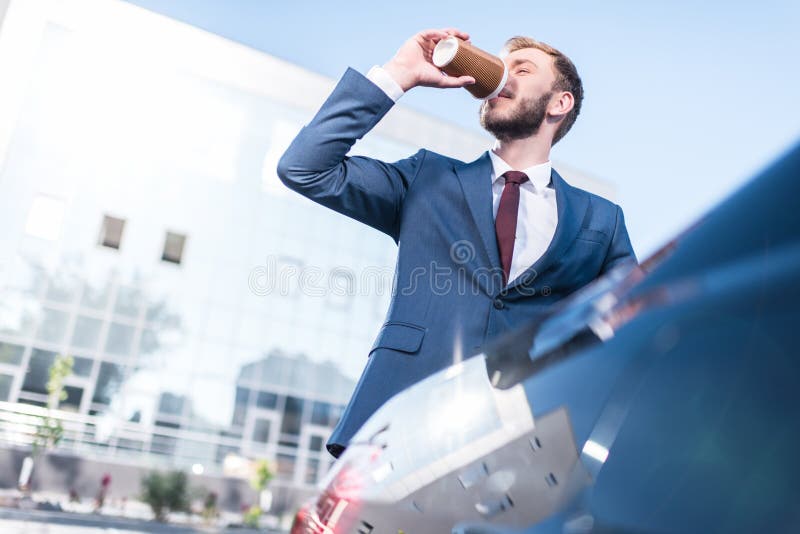 Young Businessman in Suit Drinking Coffee on Parking Stock Photo ...