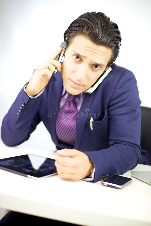 Young Businessman Talking with Two Cell Phones Stock Image - Image of ...
