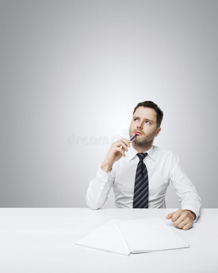 Young businessman thinking stock photo. Image of showing - 32989924