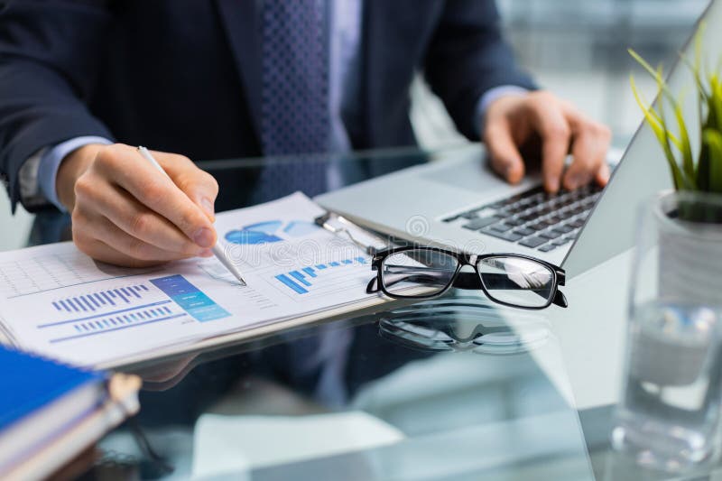 Young Businessman Typing Computer Laptop with Graph Chart for Work ...