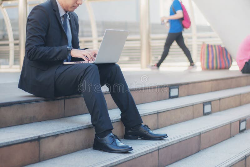 Businessman Using Computer on Stairs. Stock Photo - Image of lifestyle ...