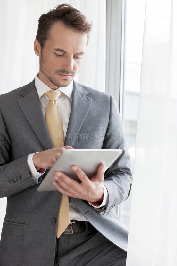 Young Businessman Using Digital Tablet in Office Stock Photo - Image of ...