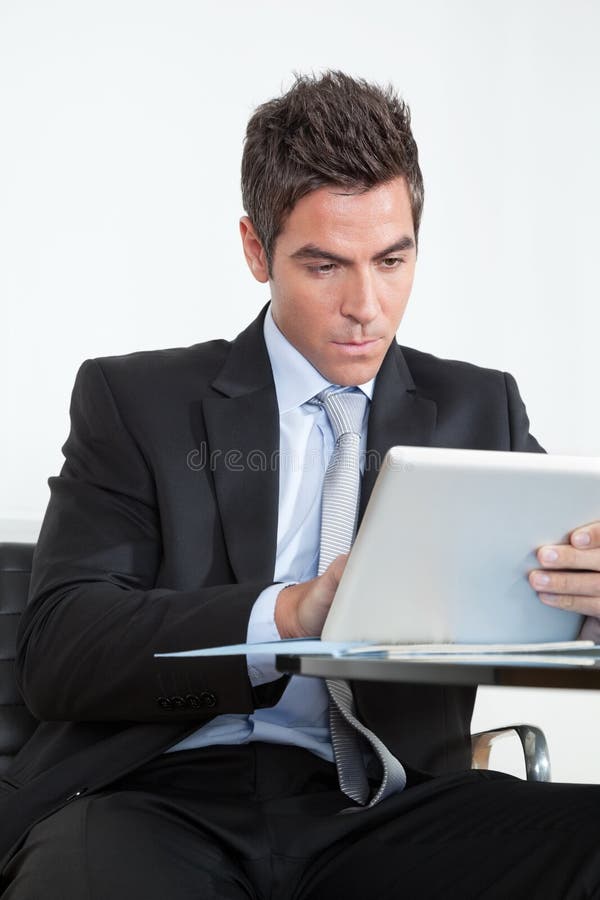 Young Businessman Using Digital Tablet in Office Stock Image - Image of ...