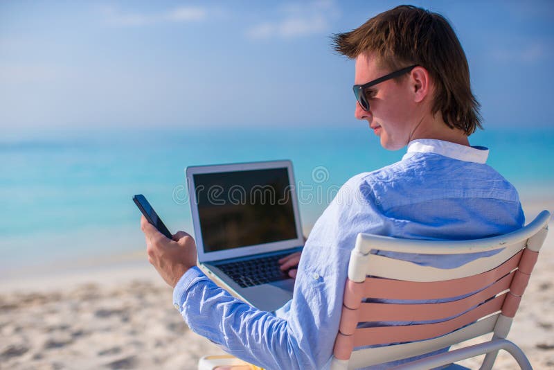 Young Businessman Using Laptop on Tropical Beach Stock Image - Image of ...