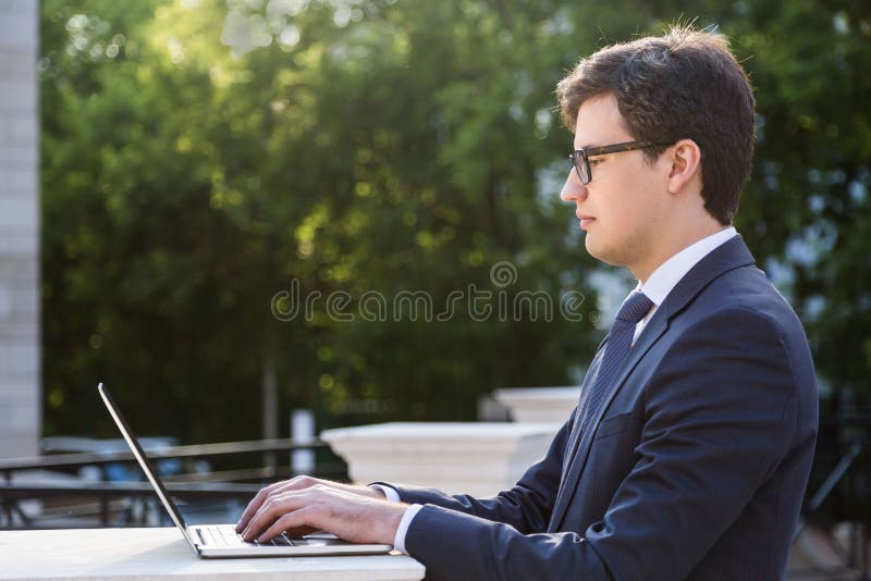 Young Businessman Using Notebook Stock Photo - Image of bench, mobile ...