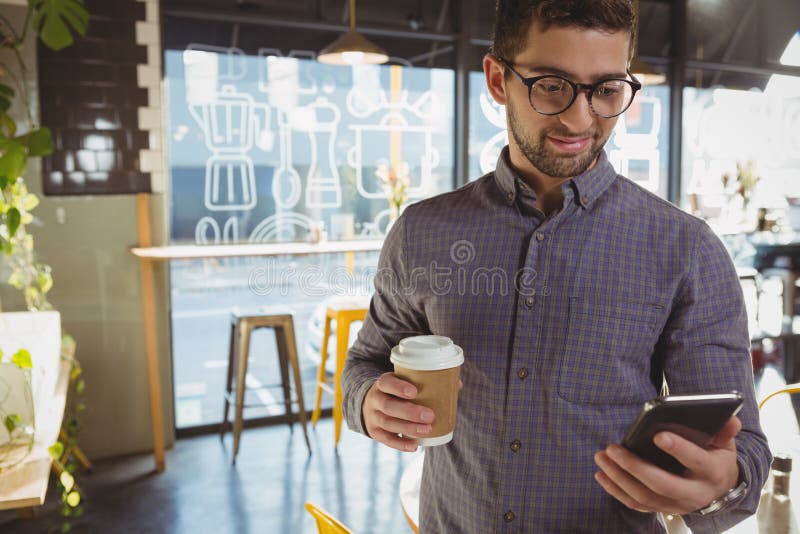 Man Using Phone while Having Coffee in Cafe Stock Photo - Image of ...
