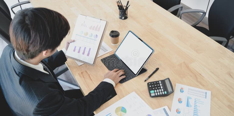 Young Businessman Working on His Current Project while Using Tablet ...