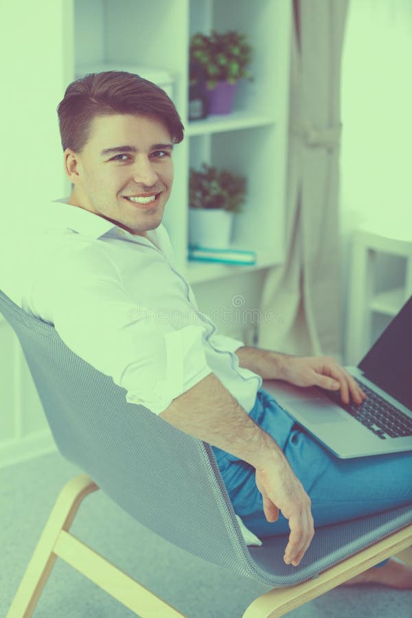 Young Businessman Working in Office, Sitting at Desk Stock Photo ...