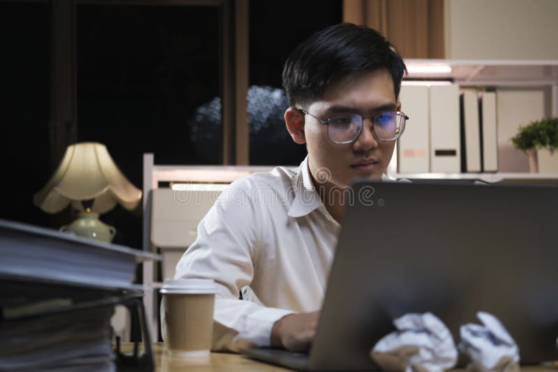 Young Businessman Working Overtime on a Desk at Night.. Stock Image ...