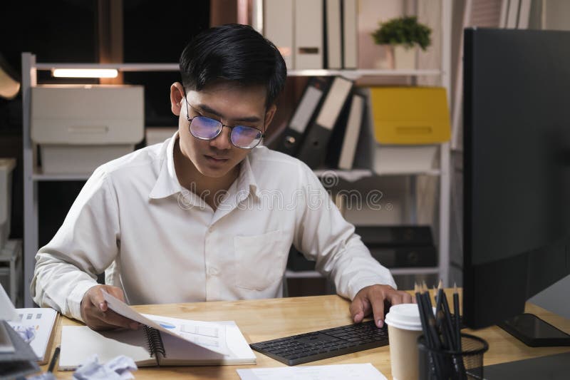 Young Businessman Working Overtime on a Desk at Night.. Stock Photo ...